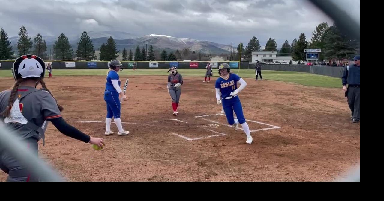 Missoula Big Sky's Syerra Peterson scores on a wild pitch against Hellgate