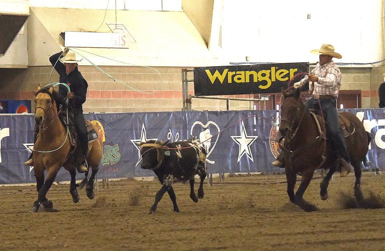 Team ropers compete in the Wrangler Roping Finals
