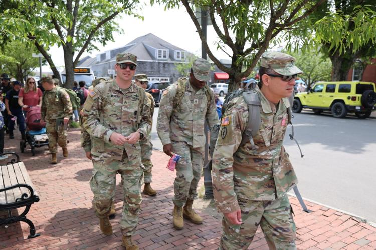 Soldiers "ruck march" through downtown to celebrate U.S. Army's 250th ...