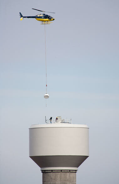 Helicopter crew installs antennas on island water towers | Crime ...