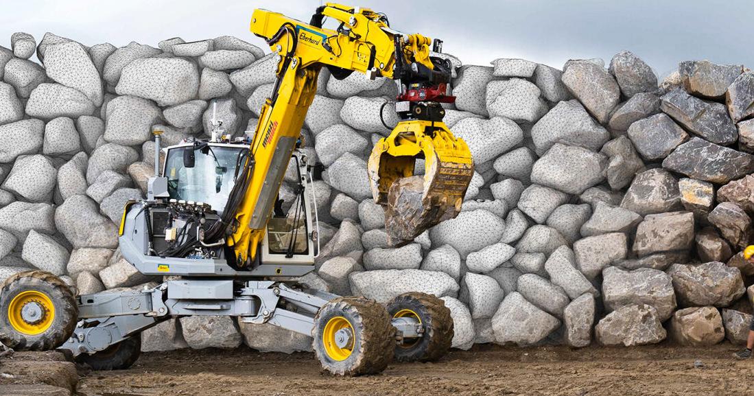 Autonomous excavator builds stone wall