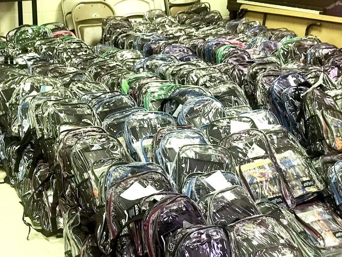 Volunteers load up backpacks to be given to children | News ...