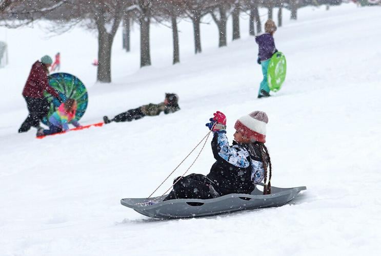 Families embrace snow day at popular sled hill | Local News ...