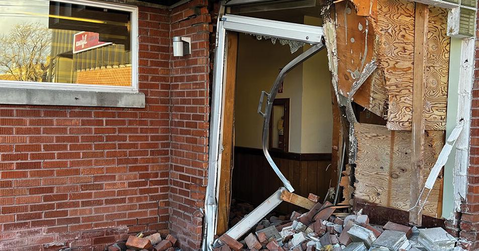 District personnel deal with repair from vehicle smashing into building ...