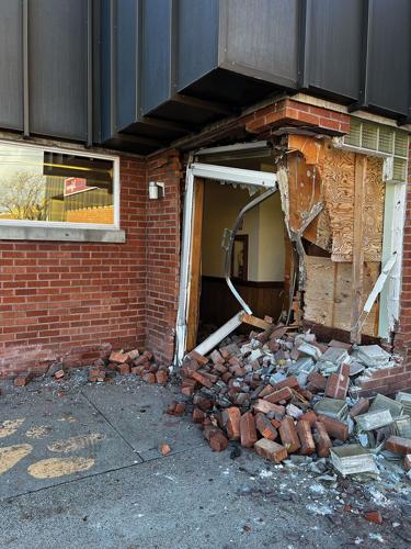 District personnel deal with repair from vehicle smashing into building ...