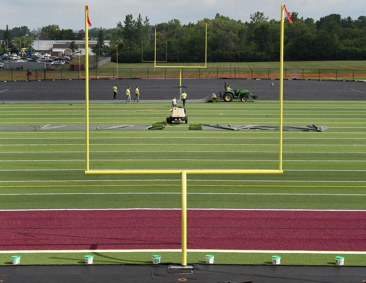Gallery: Installing the new turf field at Holland Stadium | Photo ...
