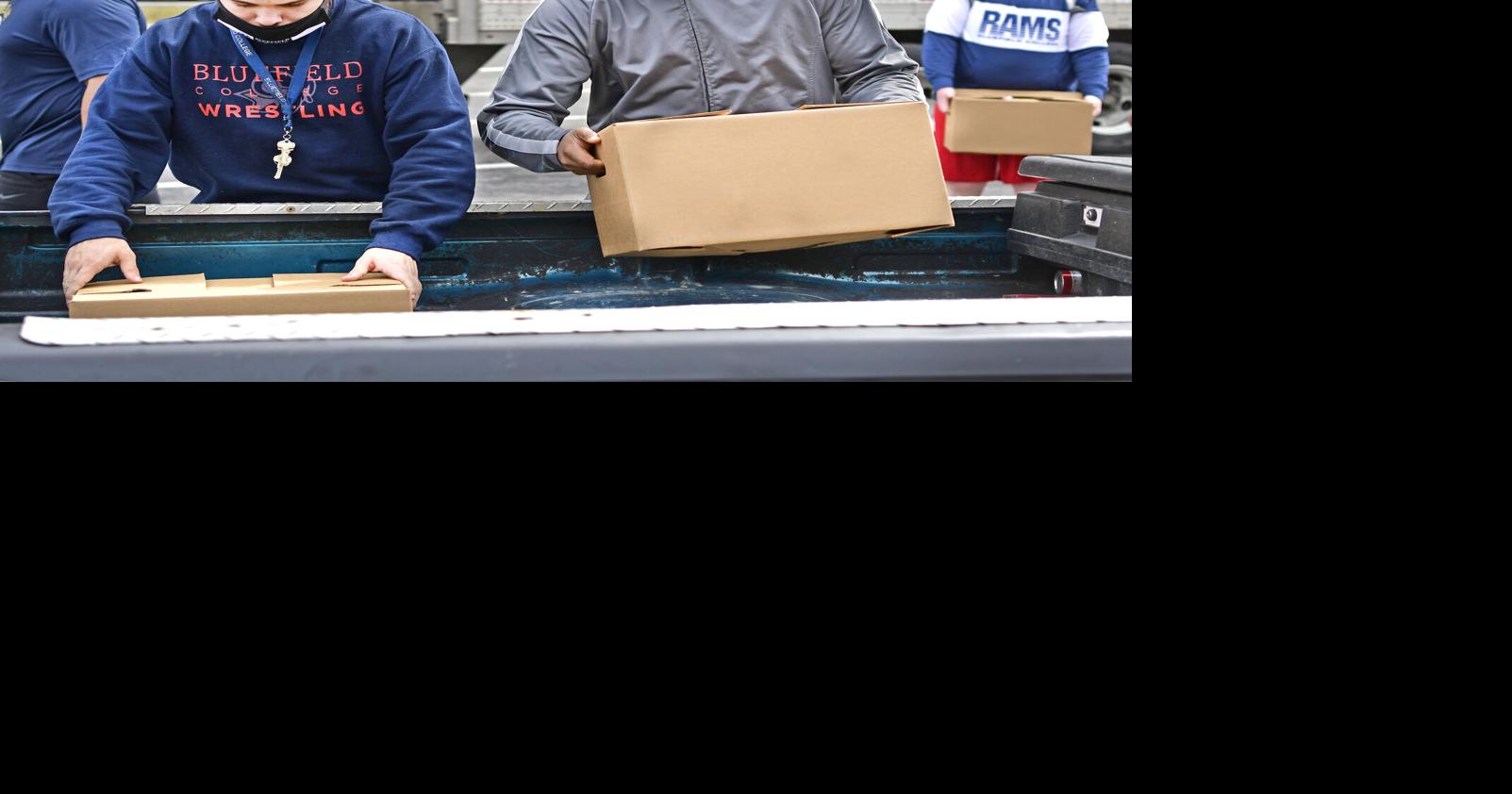 Volunteers pitch in for Save the Children food distribution | News ...