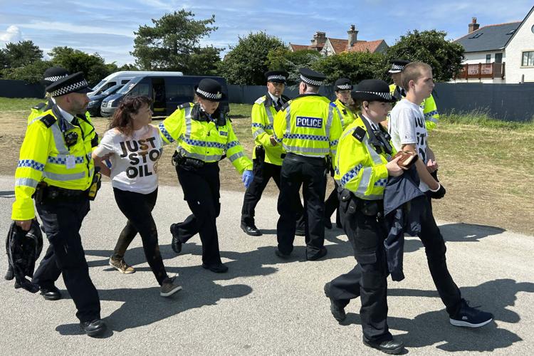 Climate change activists briefly disrupt British Open by dumping orange ...