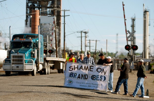 Displaced union workers hand out information at ExxonMobil refinery