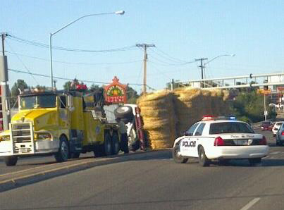 Semi dumps hay bales on Main Street