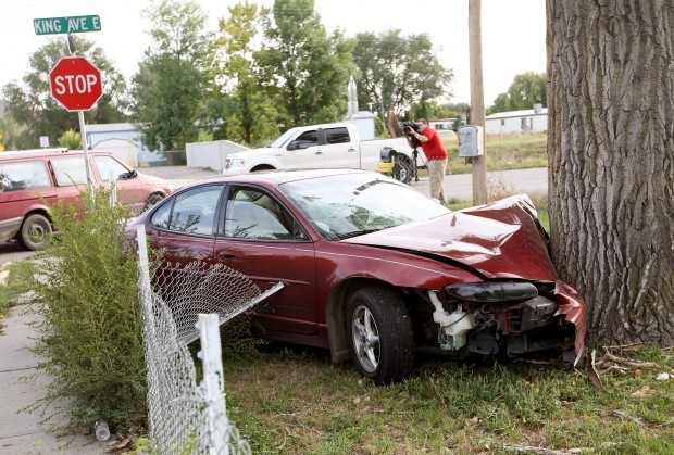 Driver leaves after car hits fence, tree