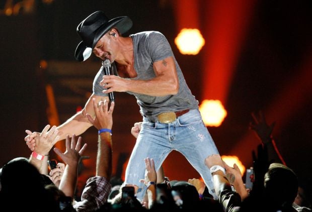 Fans dance in the aisles at McGraw concert