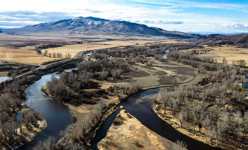 Side-by-side drivers cross Big Hole River at spawning ground