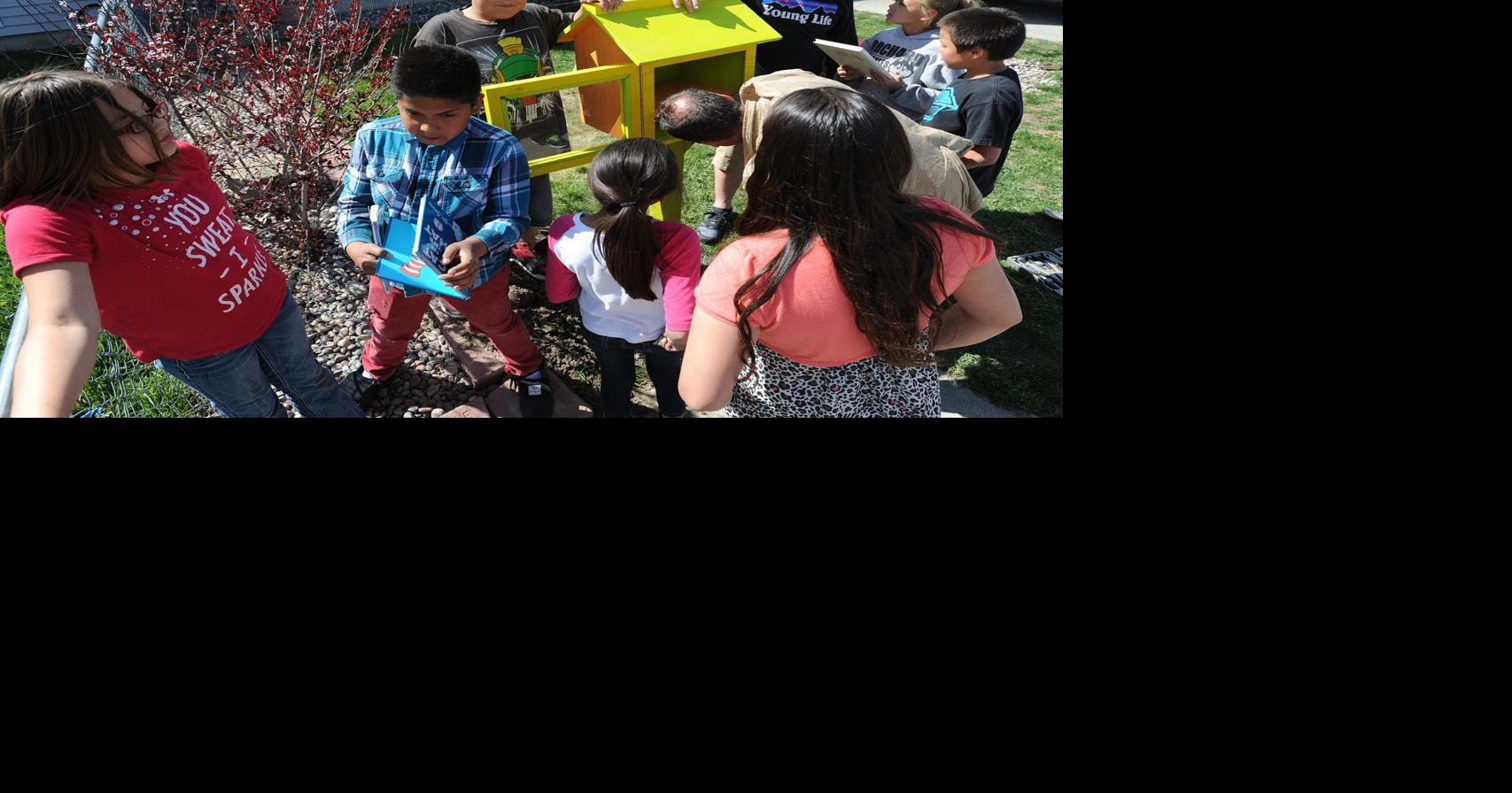 Neighborhood children help set up their own lending library