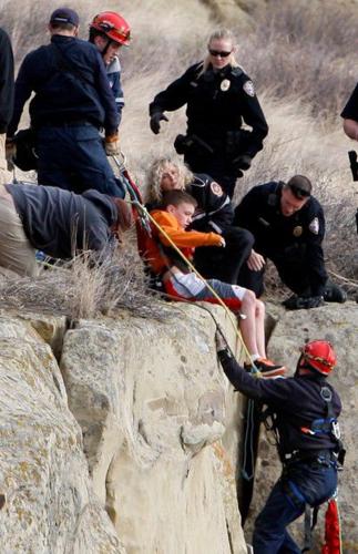 Firefighters rescue boy trapped along Rimrocks