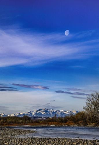 Photo: Moon sits high above the Yellowstone River and mountains near Laurel