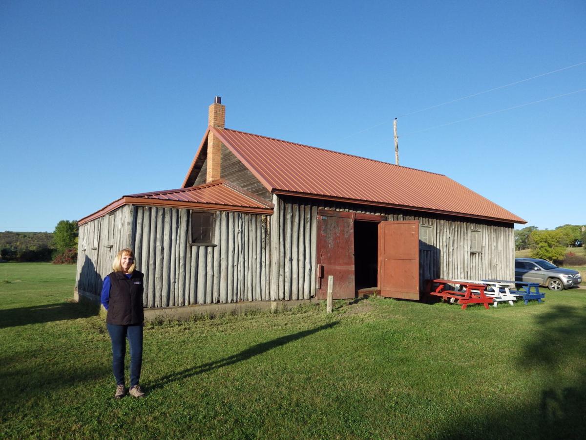 Family makes strides in restoring Depression-era log hall