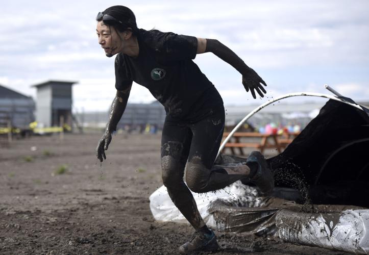 Getting dirty: runners play, climb, crawl through muddy obstacle course ...