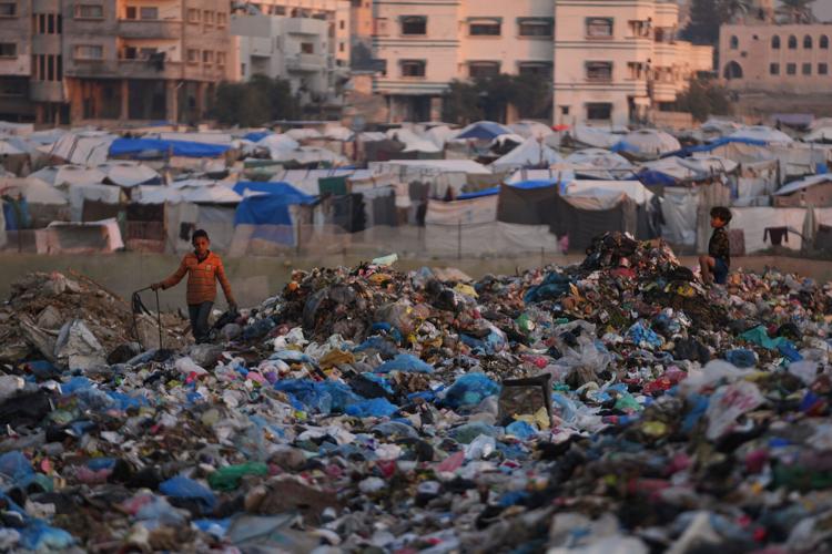 People in Gaza dig through garbage for things to burn to keep warm — a ...