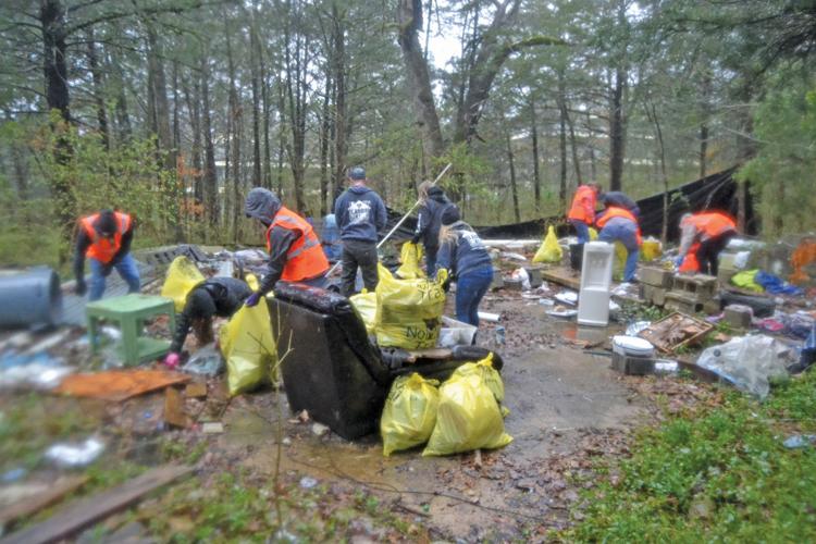 Community rallies to clean abandoned homeless camp | News Free ...