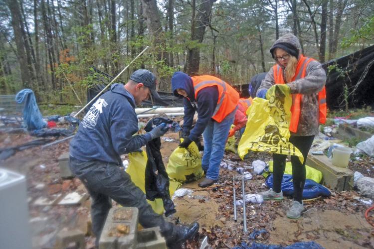 Community rallies to clean abandoned homeless camp | News Free ...