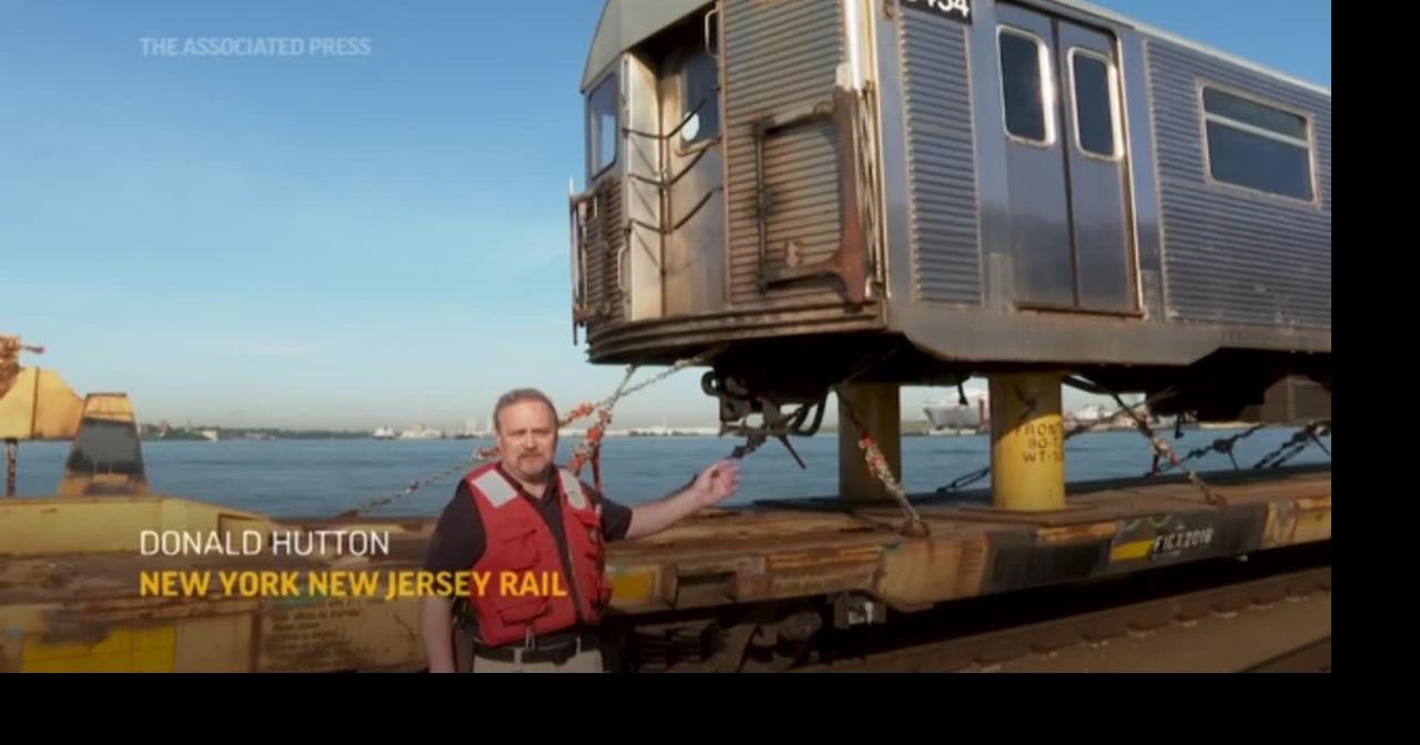 Goodbye: Old subway cars float away in NY Harbor