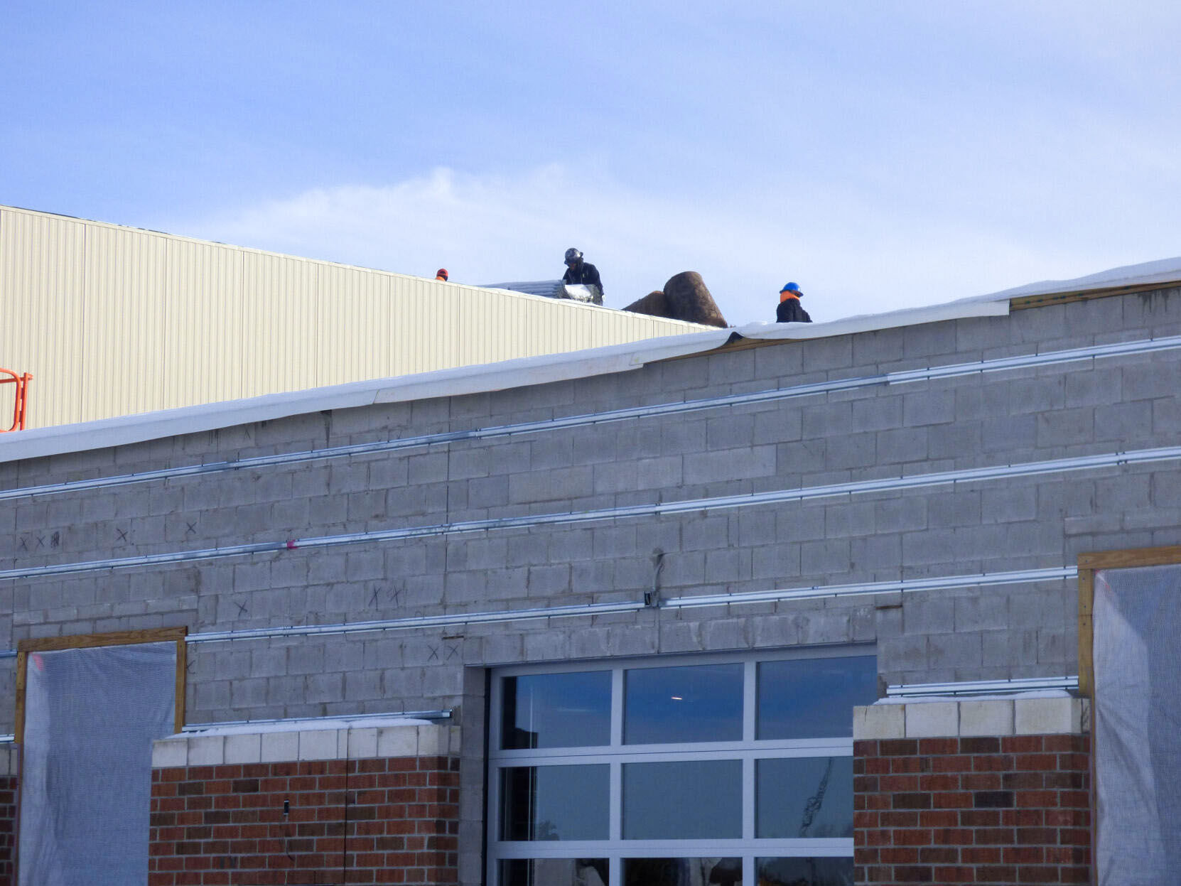 Crews working through snow to get roof on expansion project | News ...