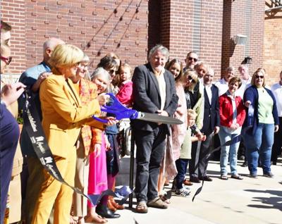 Carol Laub cuts ribbon officially opening the Carol and Jim Laub Plaza ...