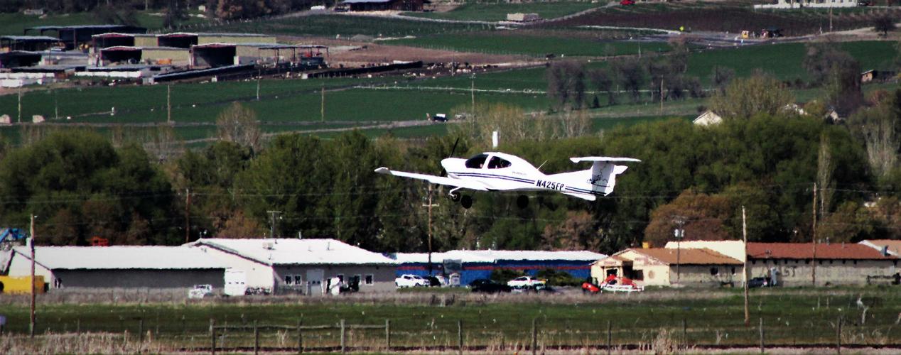 Pre-teens taking the controls of an airplane as part of Cache Makers ...