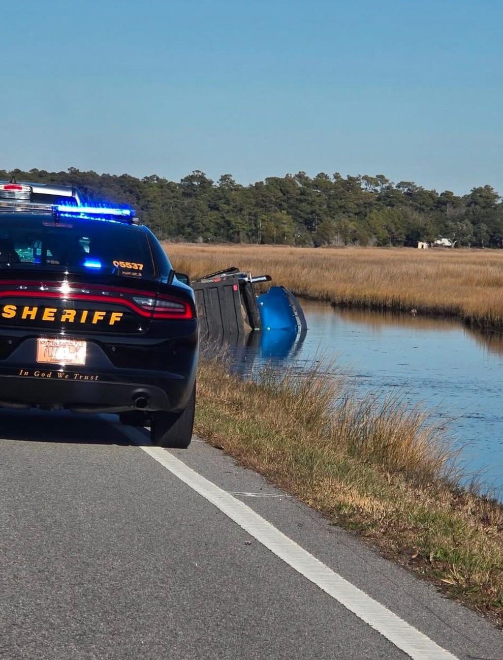 Dump truck overturns into canal near Stacy; driver escapes with minor ...