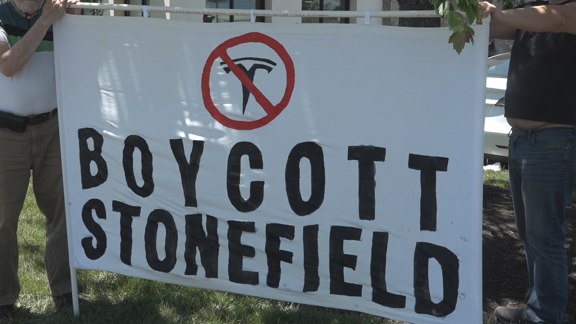 Protesters rally at Stonefield against Tesla Dealership | News ...