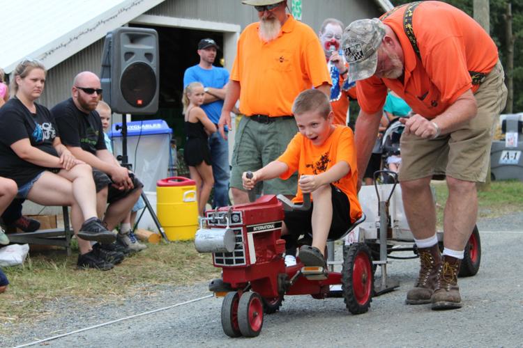 Youngsters compete in fair's pedal tractor pull | Spotlight ...