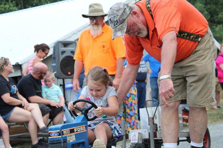 Youngsters compete in fair's pedal tractor pull | Spotlight ...