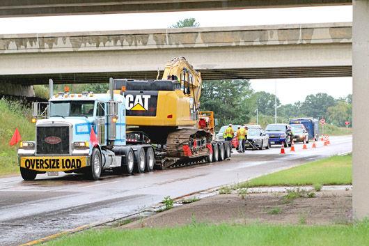 Excavator too high for bridge, collision causes minor damage ...