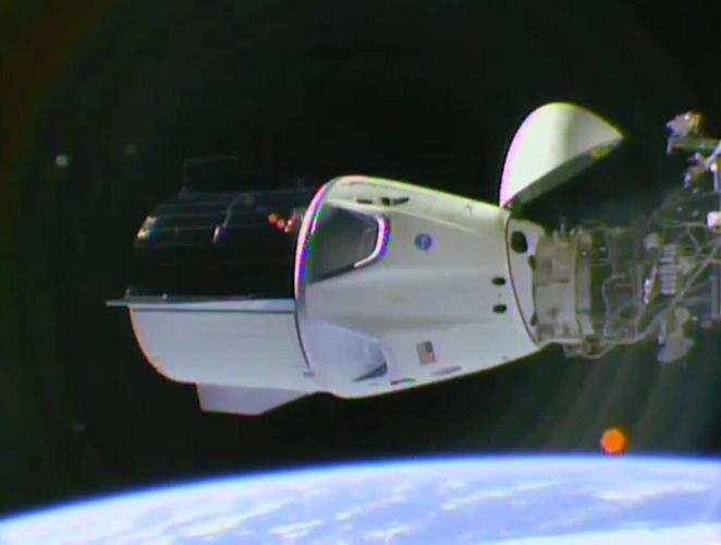 Unmanned Crew Dragon spacecraft docks with International Space Station ...
