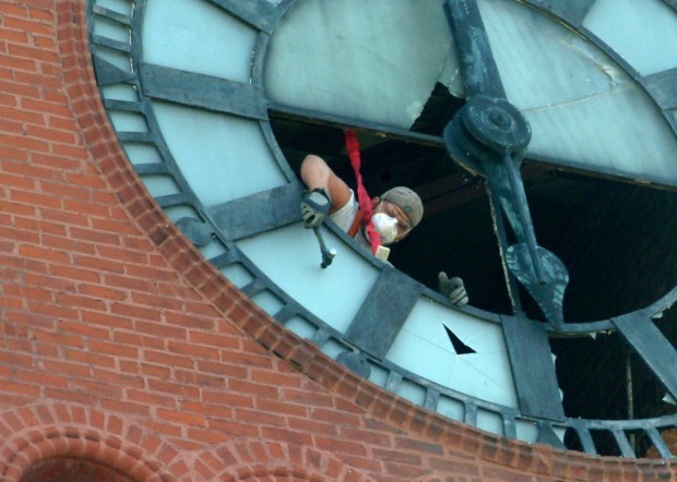 Workers restore clocks atop Bowman Hall tower