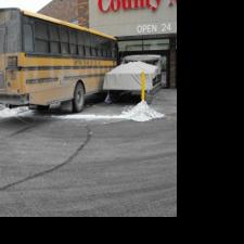 School bus rolls into pontoon, front of store