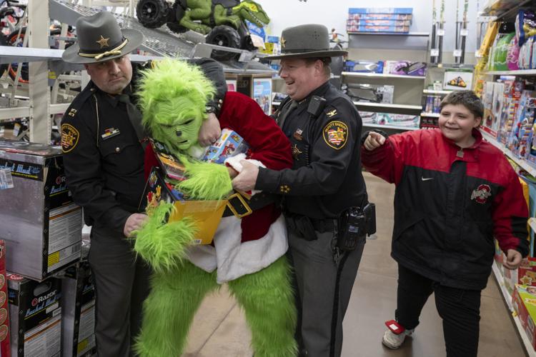 Local officers shop with kids, take Grinch to jail | News ...