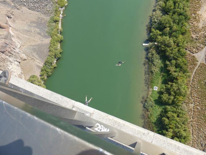 Base jumpers parachute from lofty Snake River bridge | Living ...