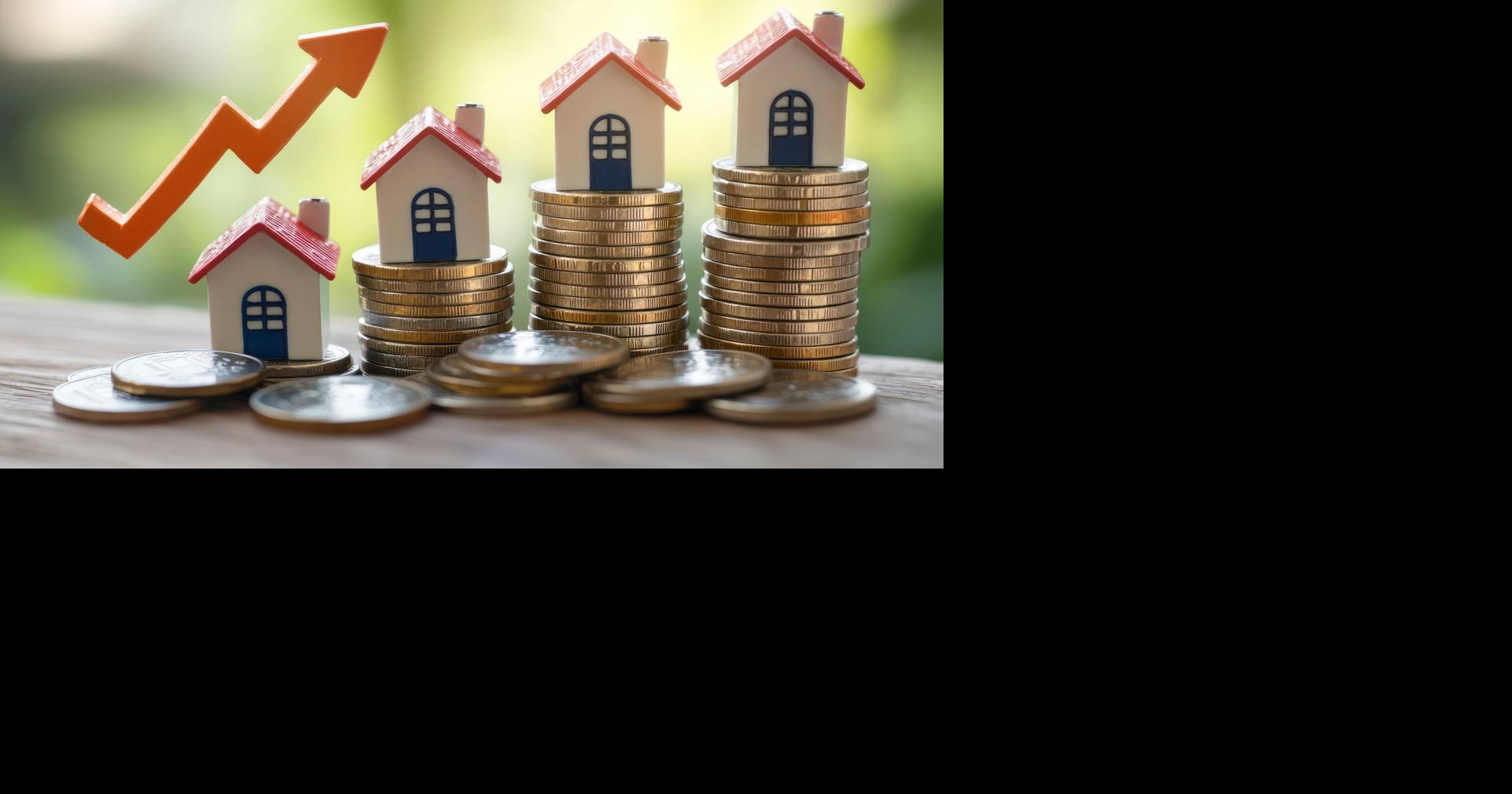 Real estate growth concept with house models and coins ...