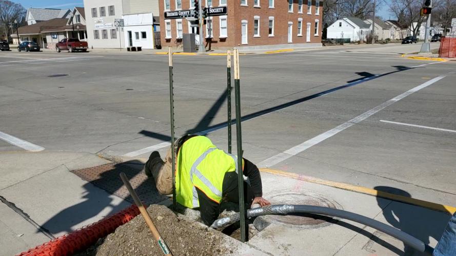 Workers run conduit for new red light traffic cameras | Local ...