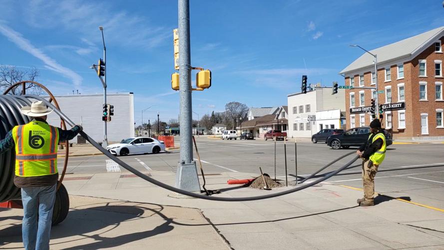 Workers run conduit for new red light traffic cameras | Local ...