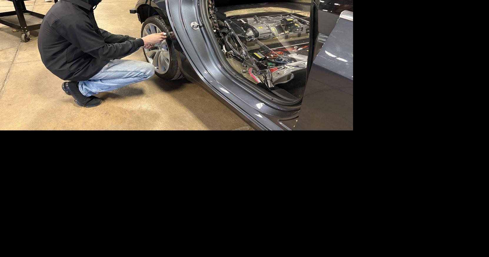 Questar automotive students work on a Tesla automobile ...