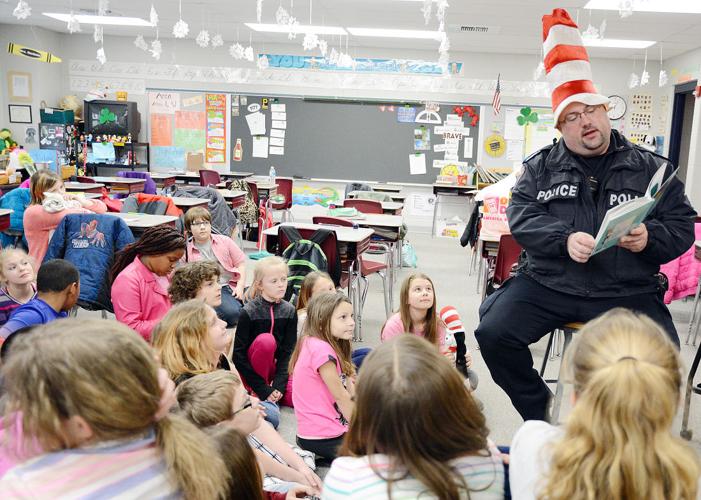 City officer reads to fourth-graders to celebrate Dr. Seuss' birthday ...