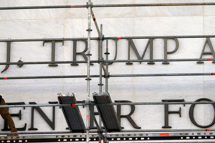 Workers begin to remove Trump's name from the Kennedy Center, in photos ...