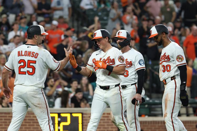 Holliday hits grand slam and Young pitches Orioles past Mariners 7-2 to ...