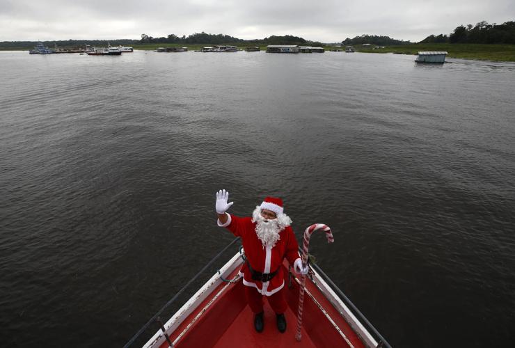 Santa braves the sticky heat of the Amazon jungle to bring gifts to ...