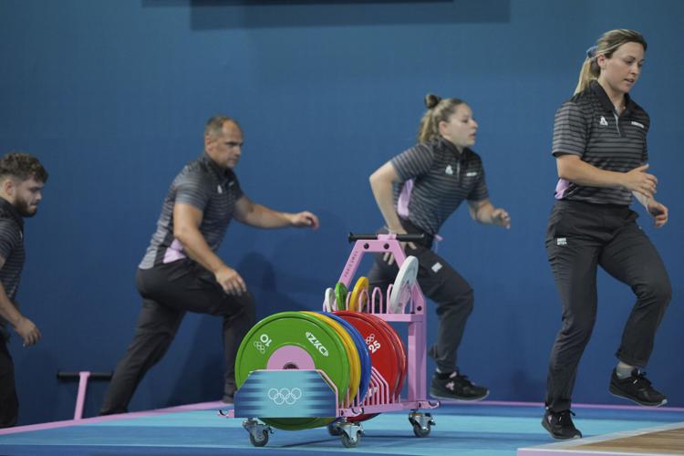 Like pit crews but in weightlifting. How loaders keep the Olympic sport ...