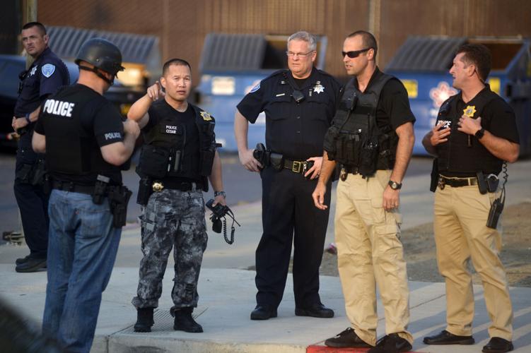 Police report 2 shot, 1 dead; 2 in custody after gunfight shuts down ...