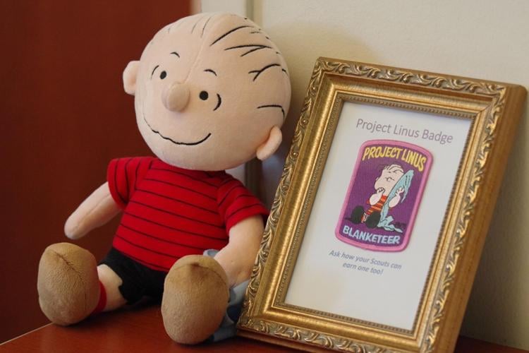 Kids and adults come to make blankets for Project Linus at library ...